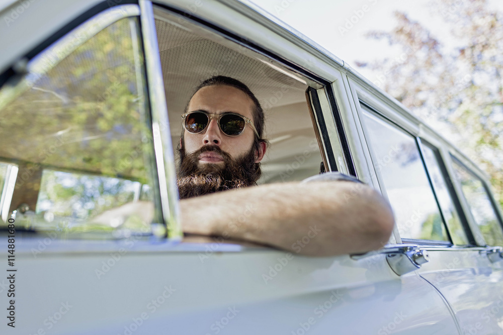 Handsome young man looking out through car window Stock Photo | Adobe Stock