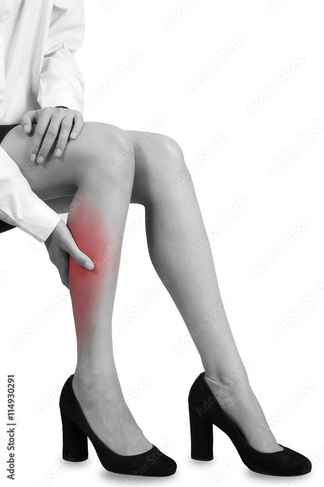 Woman holding her calf in pain area, with red highlighted, black and ...