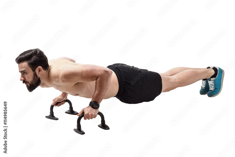 Side view of shirtless fit athlete workout on push up handles. Full ...