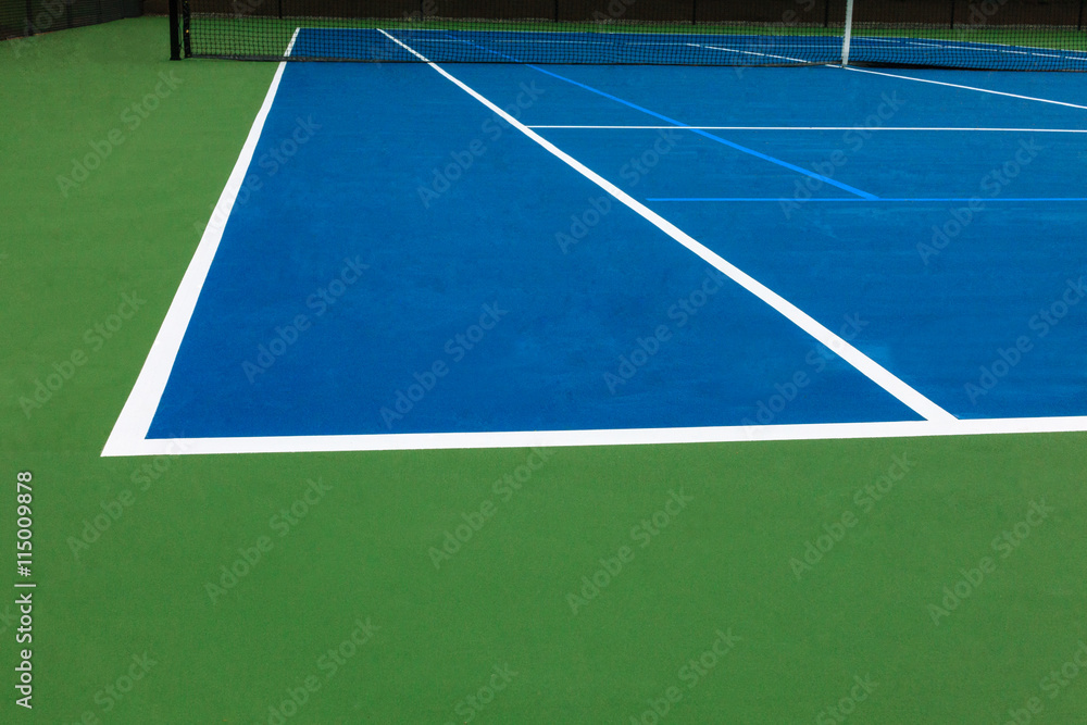 Blue tennis court surface with green texture, white lines and black net ...