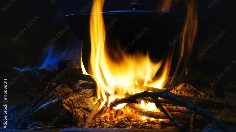 Burning fire with hot pot. Hot food preparation above burning wood ...
