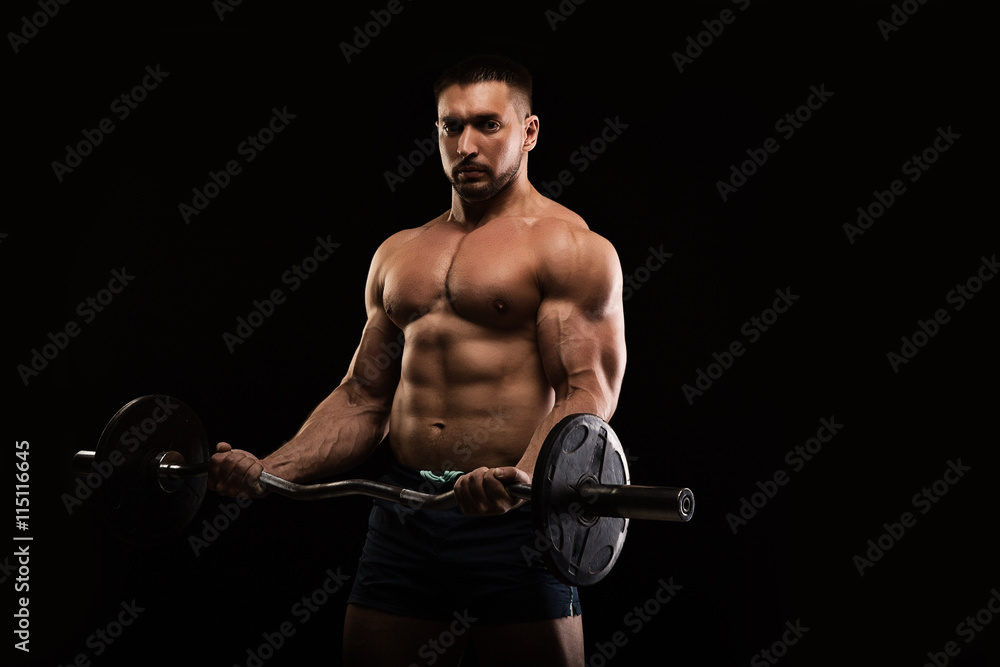 handsome muscular bodybuilder posing on a black background Stock Photo ...