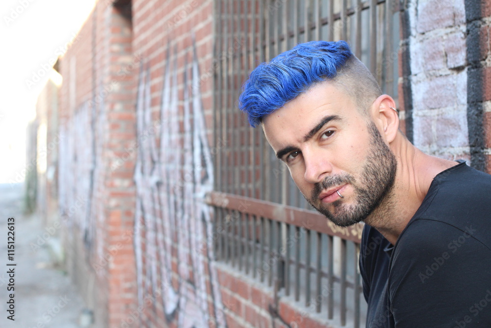 Close-up portrait of a beautiful young man with blue hair. Men's beauty ...
