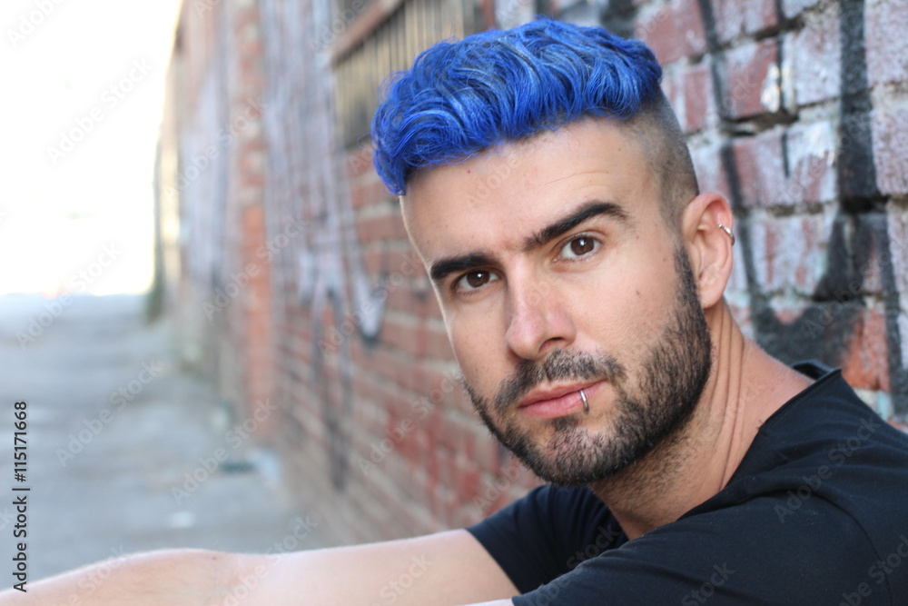 Handsome stylish young man with artificially coloured blue dyed hair ...