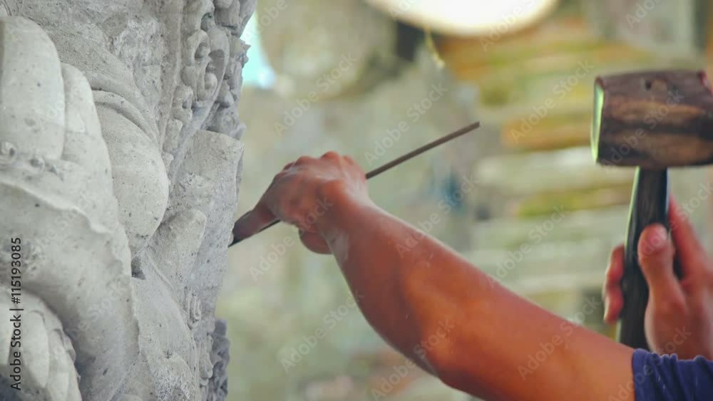 Asian sculptor, painstakingly chipping away at fine, intricate details ...