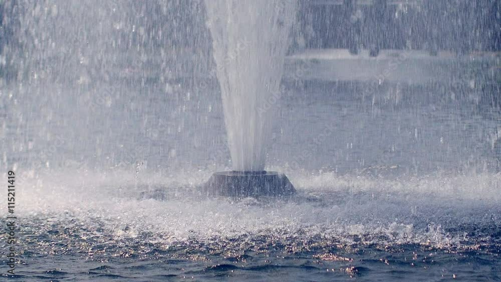 Water drops splashing on water surface in slow motion. Close up of ...