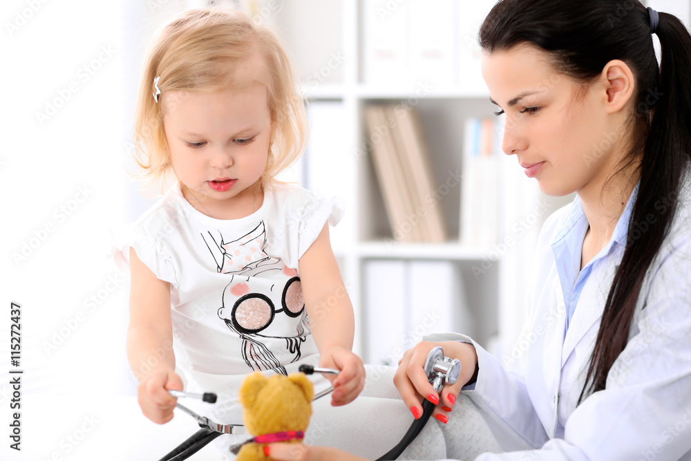 Pediatrician is taking care of baby in hospital. Little girl is being ...