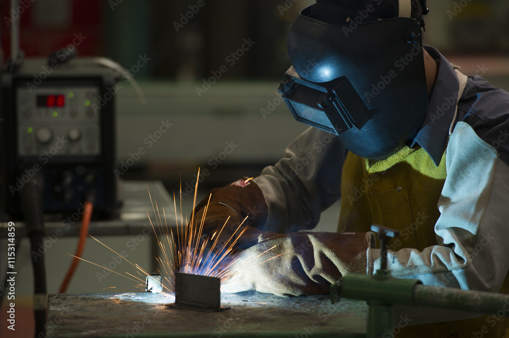 man welding steel by skill.Men wear protective clothing during work ...