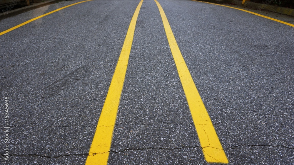yellow line on street divided between car at parking lot of load Stock ...