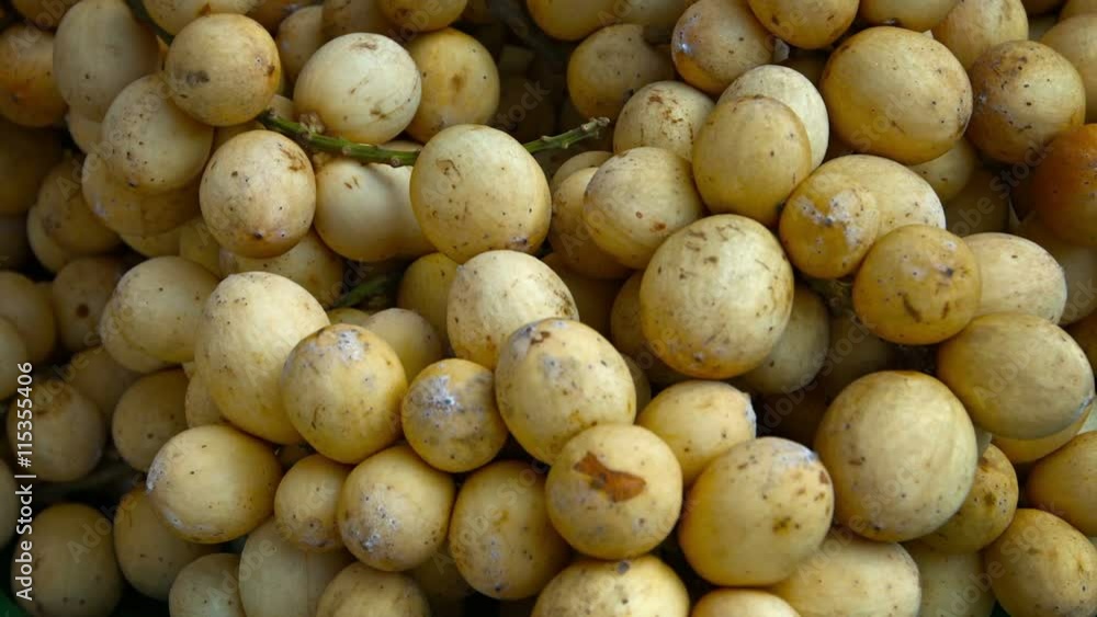 FullHD video - Small, round, sweet lanzones fruit, still clustered on ...