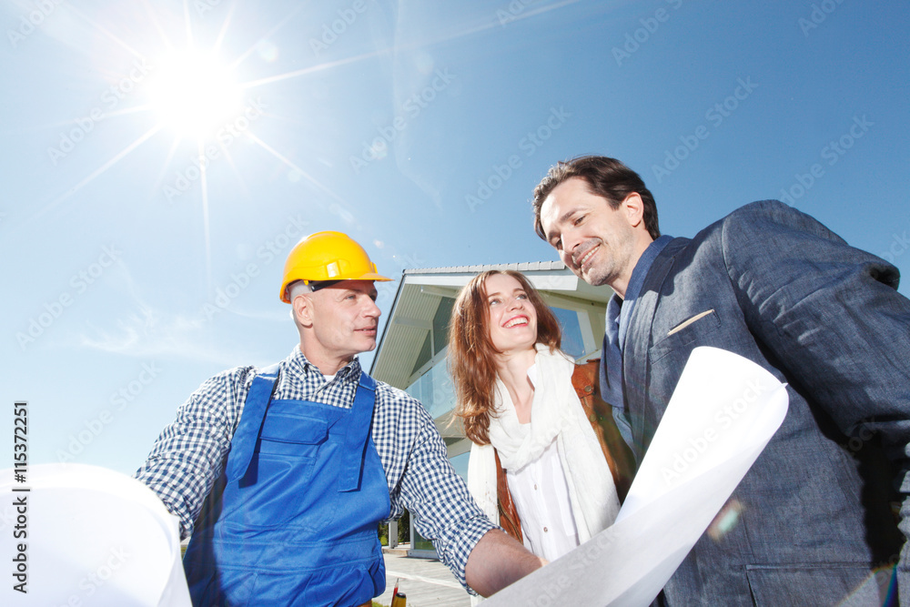 Worker shows house design plans Stock Photo | Adobe Stock