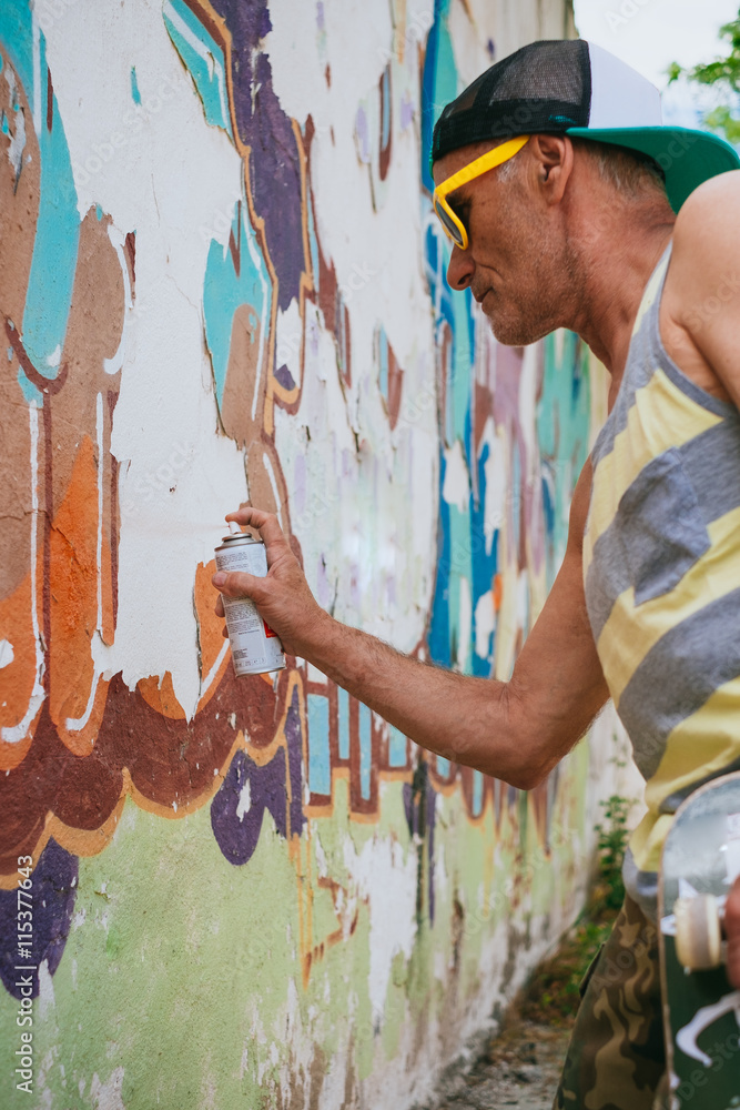 Senior Hipster Man Painting a Graffiti on a Wall with Spray Stock Photo ...