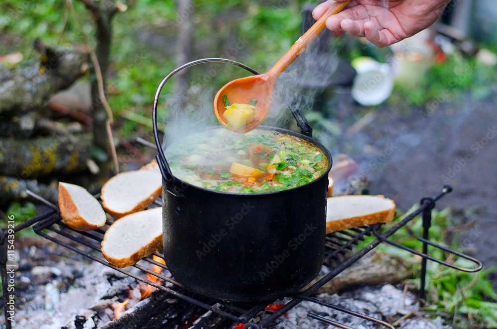The cooking of soup on the fire Photos | Adobe Stock