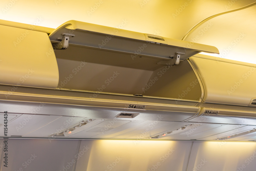 Overhead compartment in commercial aircraft. Stock Photo | Adobe Stock