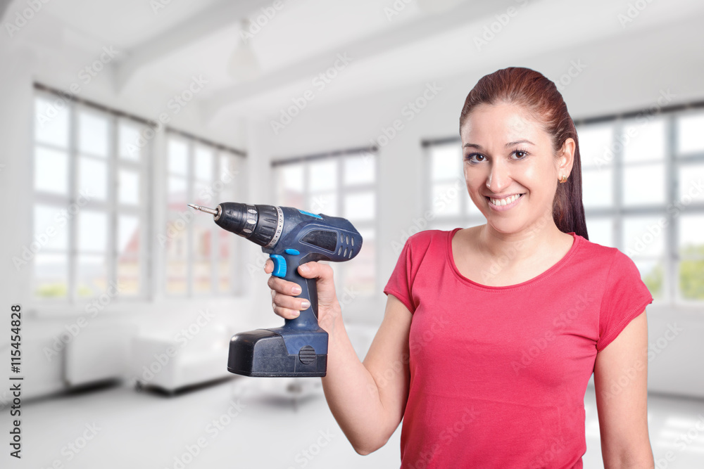 Young woman with a electric drill Stock Photo | Adobe Stock