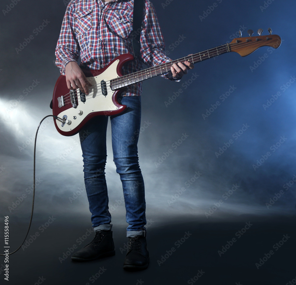 Young man playing electric guitar on lighted foggy background Stock ...