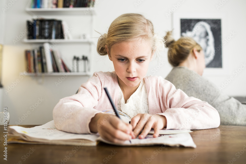 Girl writing in workbook Stock Photo | Adobe Stock