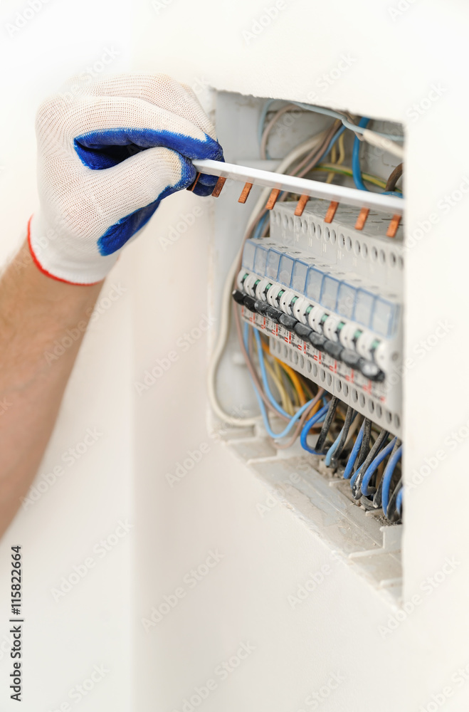 Electrician installing an electrical fuse box . Stock Photo | Adobe Stock