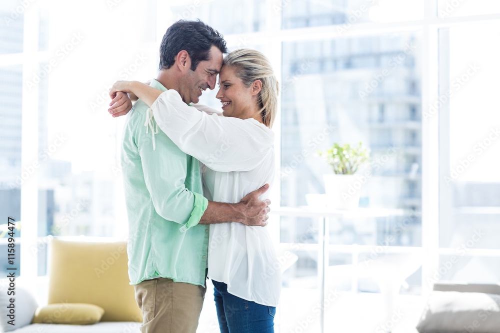 Side view of couple hugging at home Stock Photo | Adobe Stock