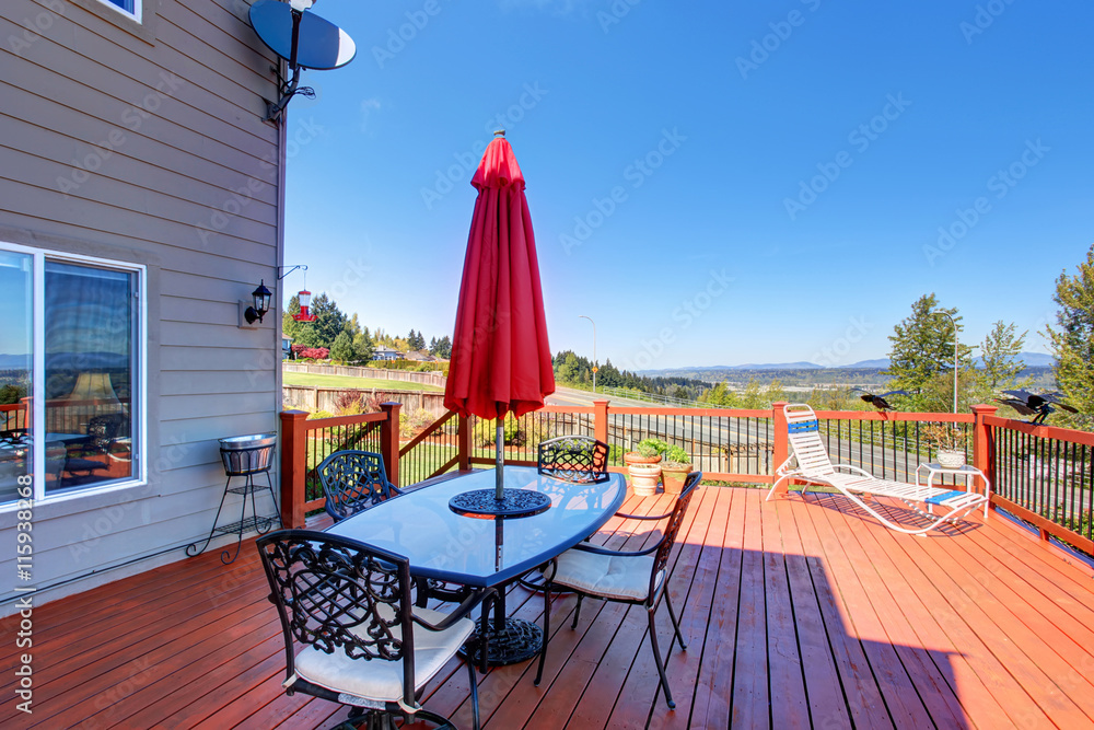 Wooden walkout deck with patio table overlooking beautiful landscape ...