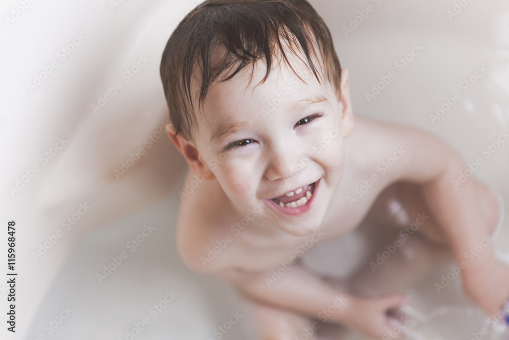 Young Boy Taking a Bath 3 / A young boy in a bath tub laughing and looking up. Stock Photo ...