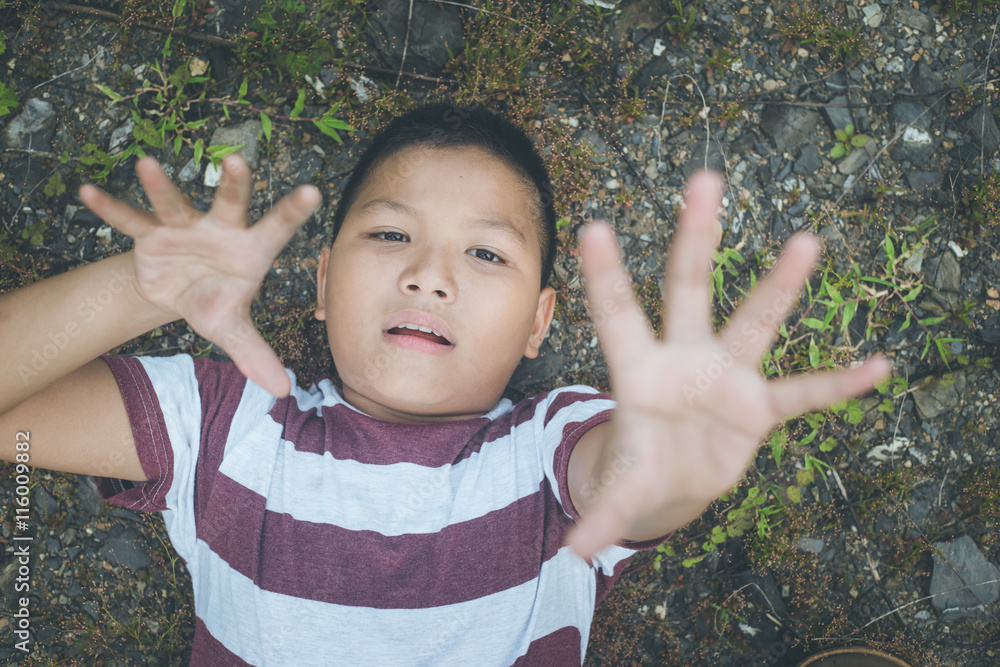 Foto de scared and alone, young homeless Asian child who is at high ...