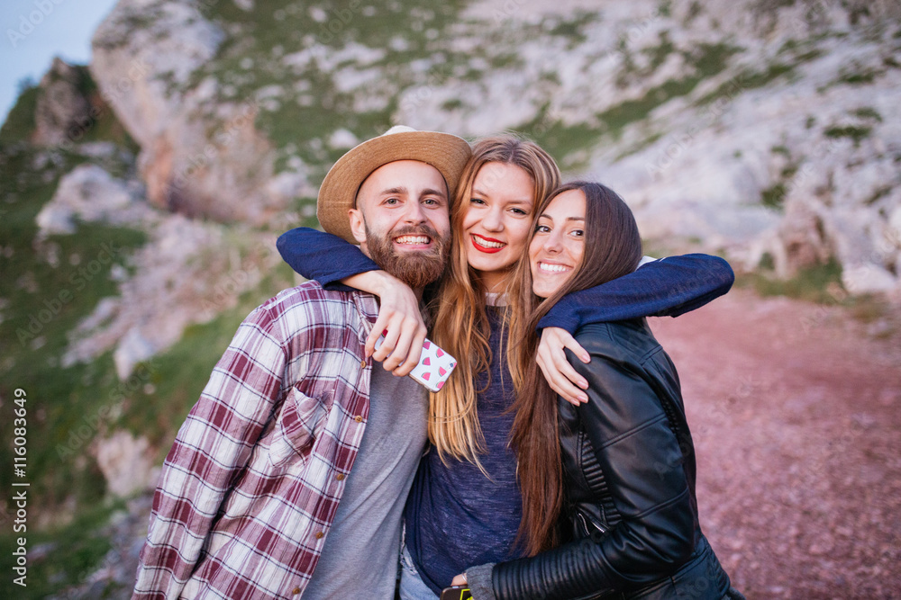 Foto Stock Three friends having fun in a mountain. | Adobe Stock