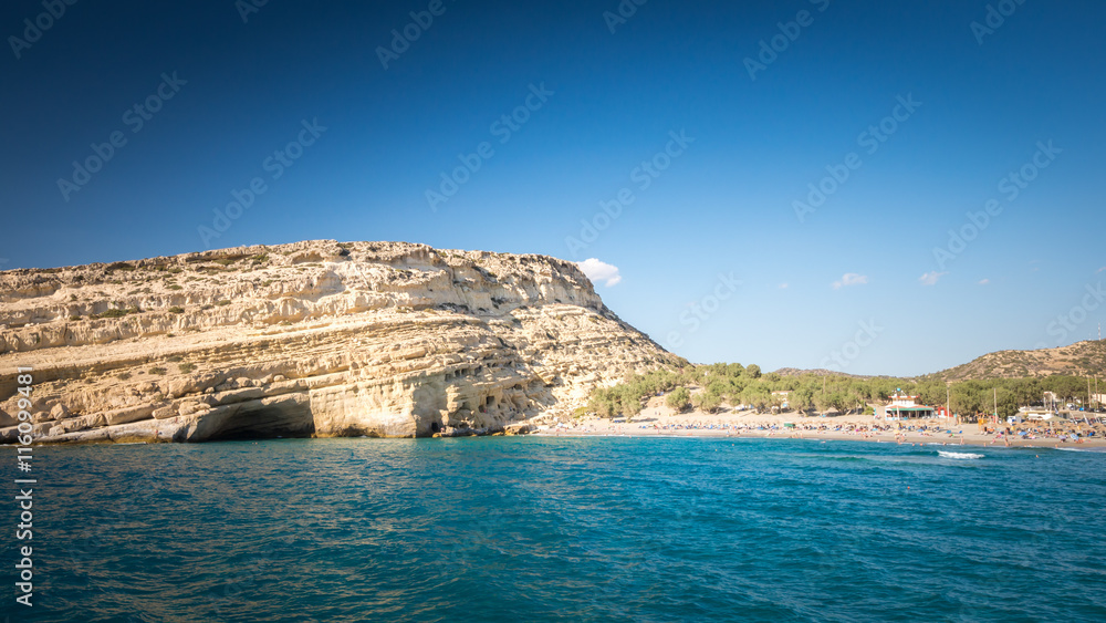Matala beach on Crete island, Greece. Tourists relax and bath in ...
