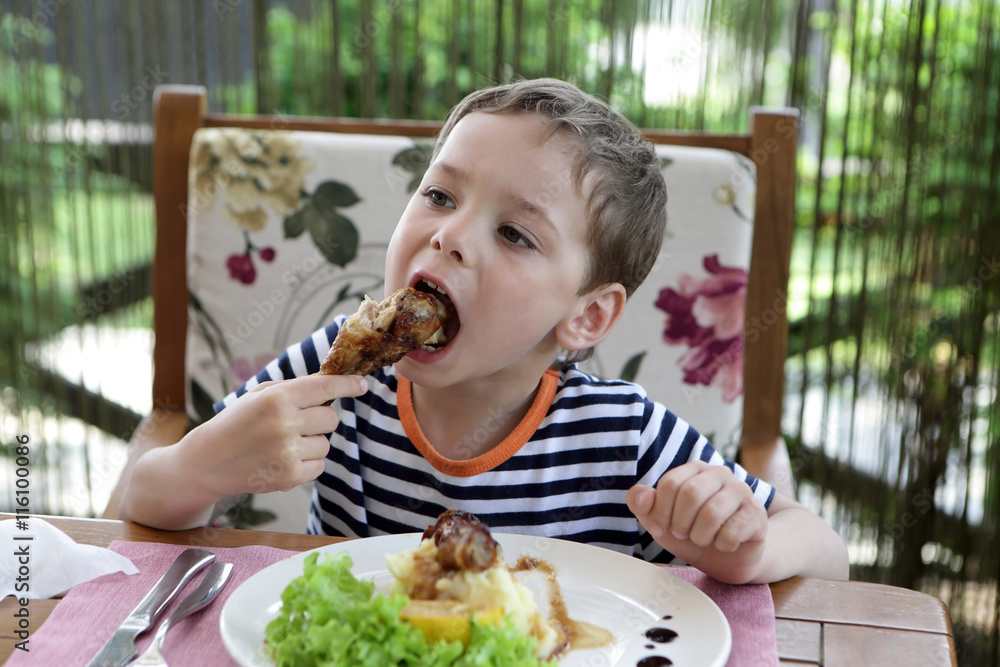 Child eating chicken leg Stock Photo | Adobe Stock