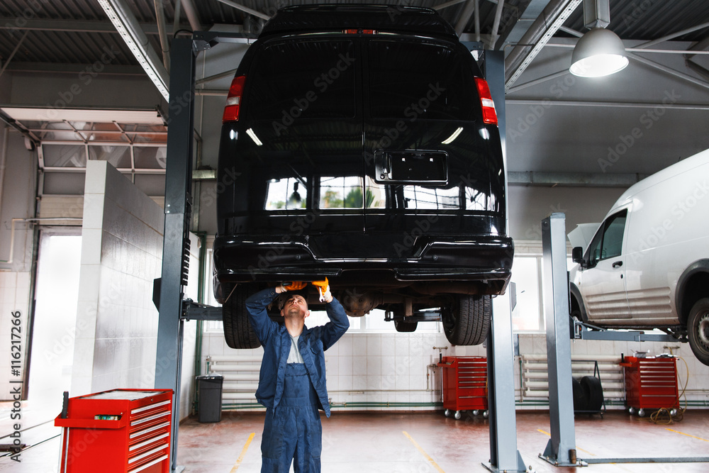 Minibus service maintenance, professional garage interior, lifted car ...