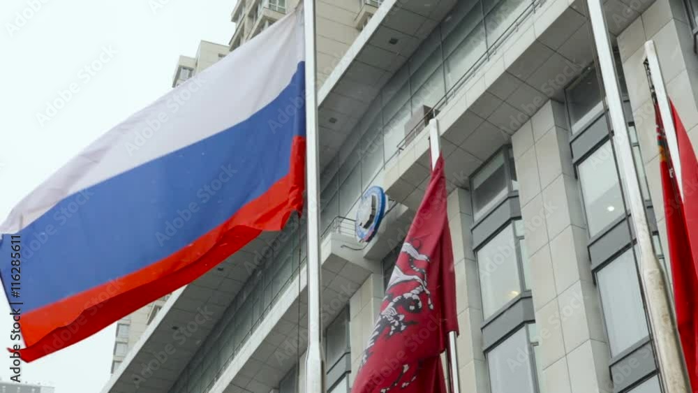 Three Flags Fluttering in the Wind Under Rain Against the Background of ...