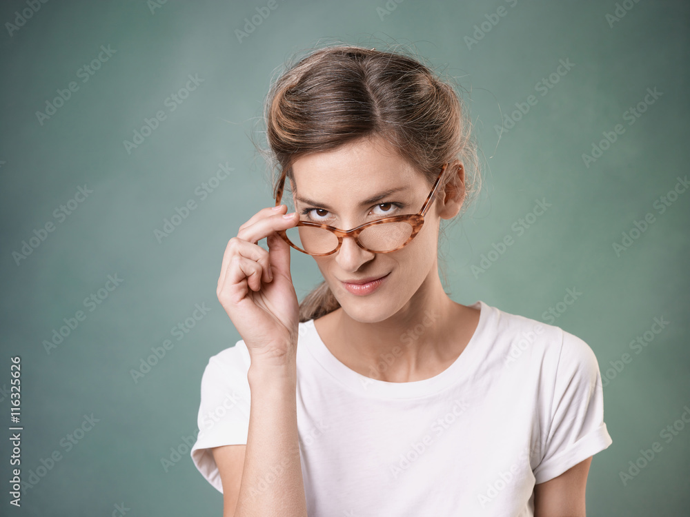 Pretty woman looking over glasses Stock Photo | Adobe Stock