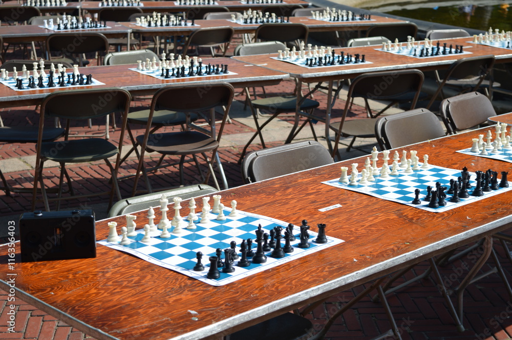 Szachy - stoliki z ułożonymi planszami. Stock Photo | Adobe Stock
