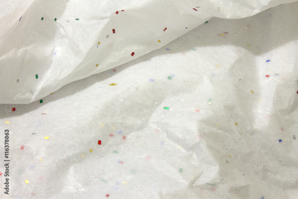 This is a photograph of White tissue wrapping paper with confetti ...