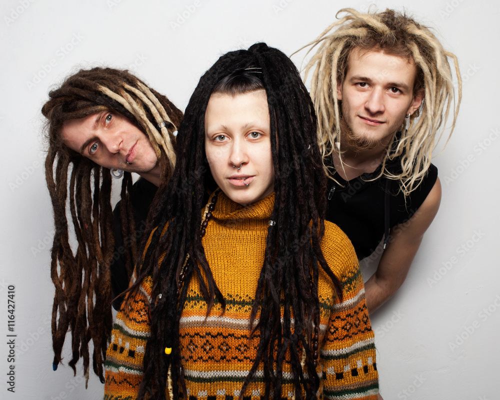 Group portrait of three young freaks with dreadlocks - two boys are ...