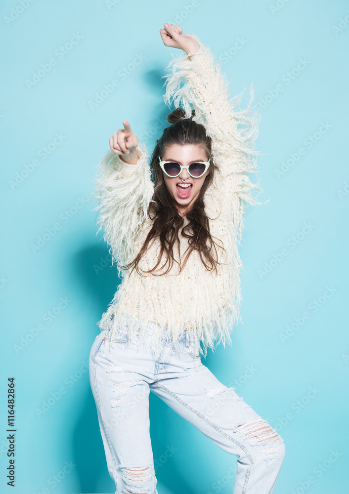 portrait of cheerful fashion hipster girl going crazy making funny face ...