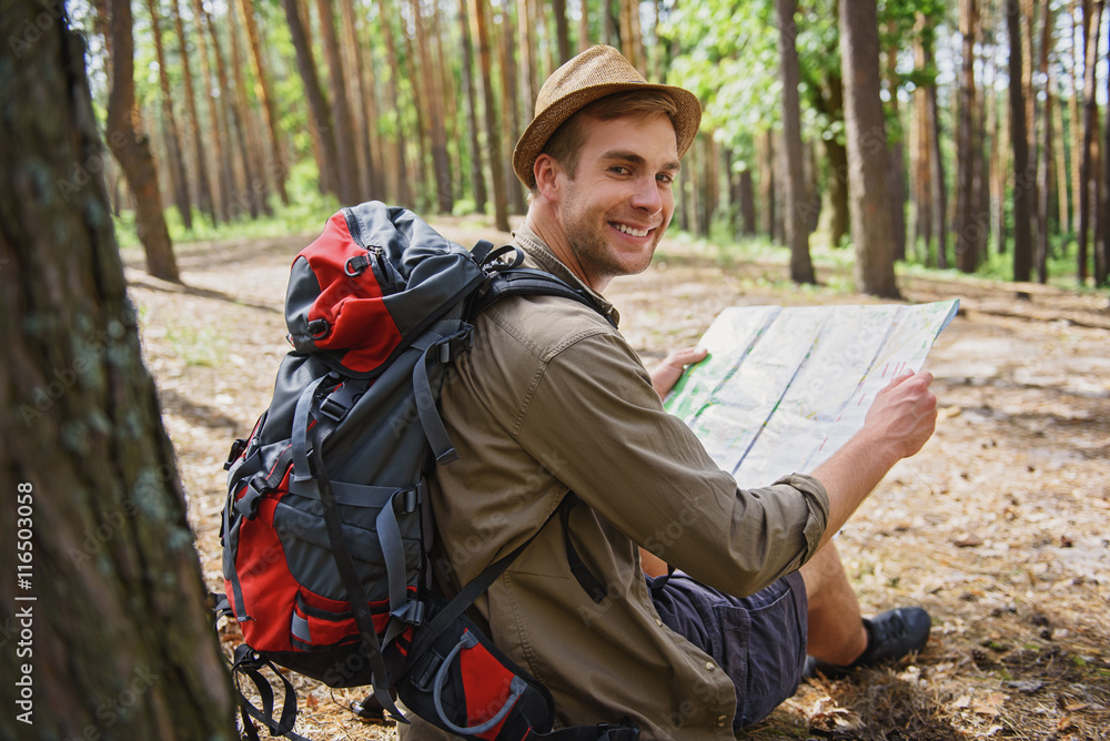 Happy male adventurer navigating in forest Stock Photo | Adobe Stock