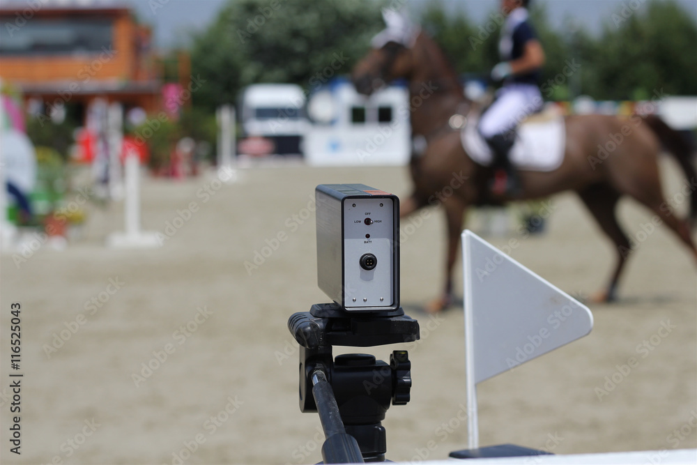 Starting timekeeper at show jumping competition, starting line with the ...