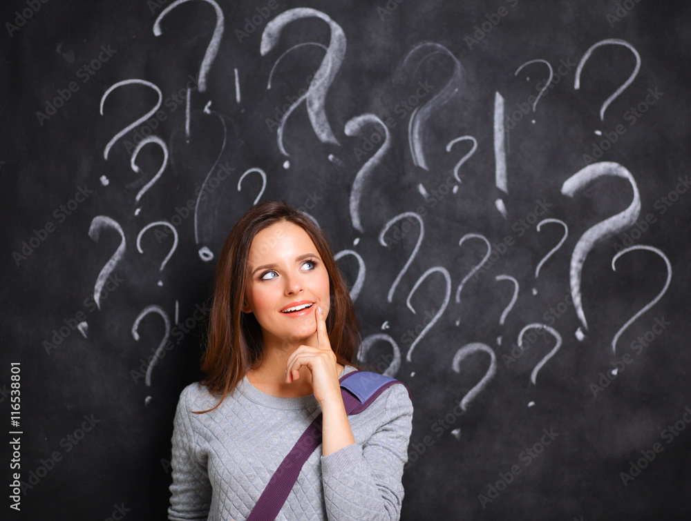 Young girl with question mark on a gray background Stock Photo | Adobe ...