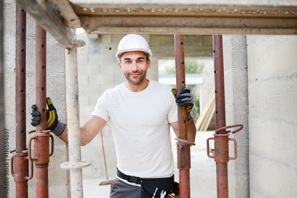 portrait of handsome construction worker on a building industry ...