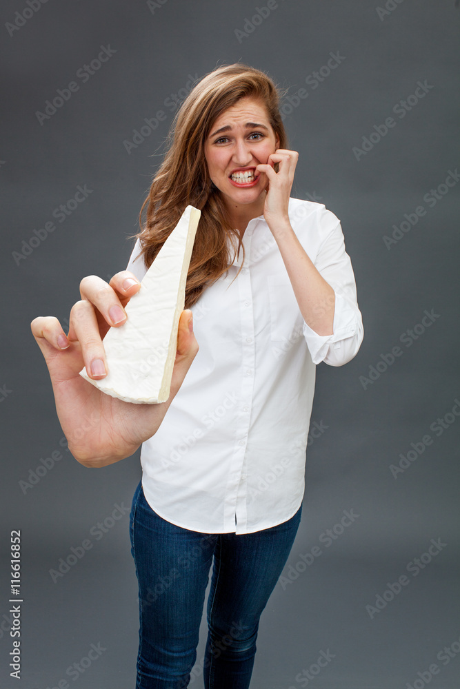 nervous young woman being scared in showing critical dairy product ...