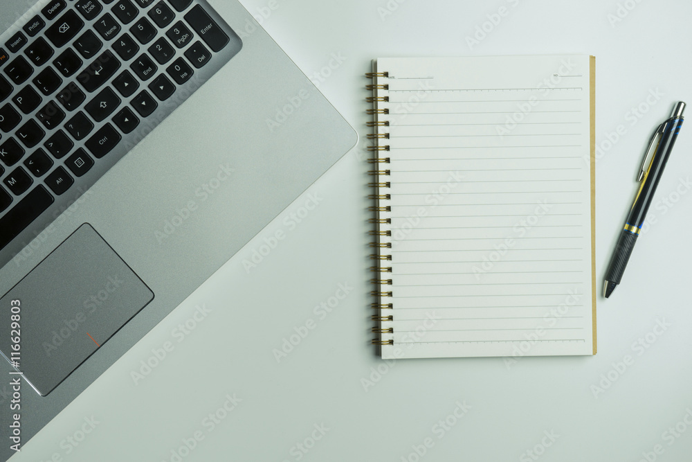 Top view of office white desk table with laptop computer, notebook and ...