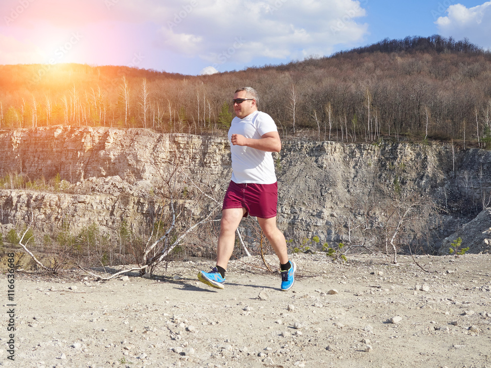 Fat man running in nature. Stock Photo | Adobe Stock