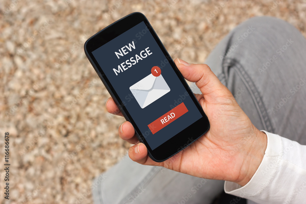 Hand holding smart phone with new message concept on screen. All screen ...