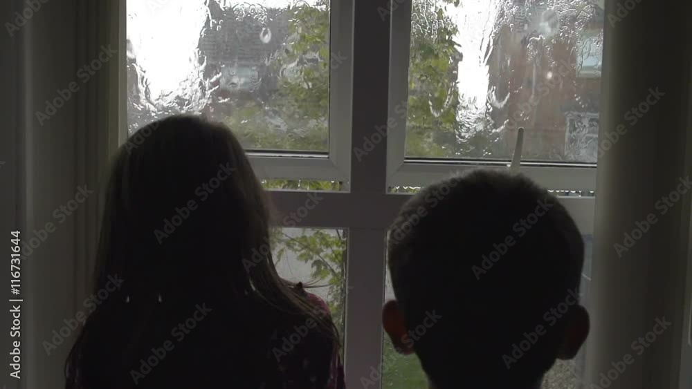 Children Watching Raindrops In A Thunderstorm. Silhouette of a little ...
