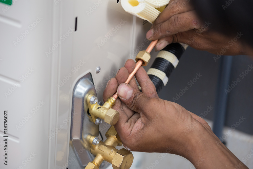 installation of air conditioner, worker connects copper pipe Stock ...