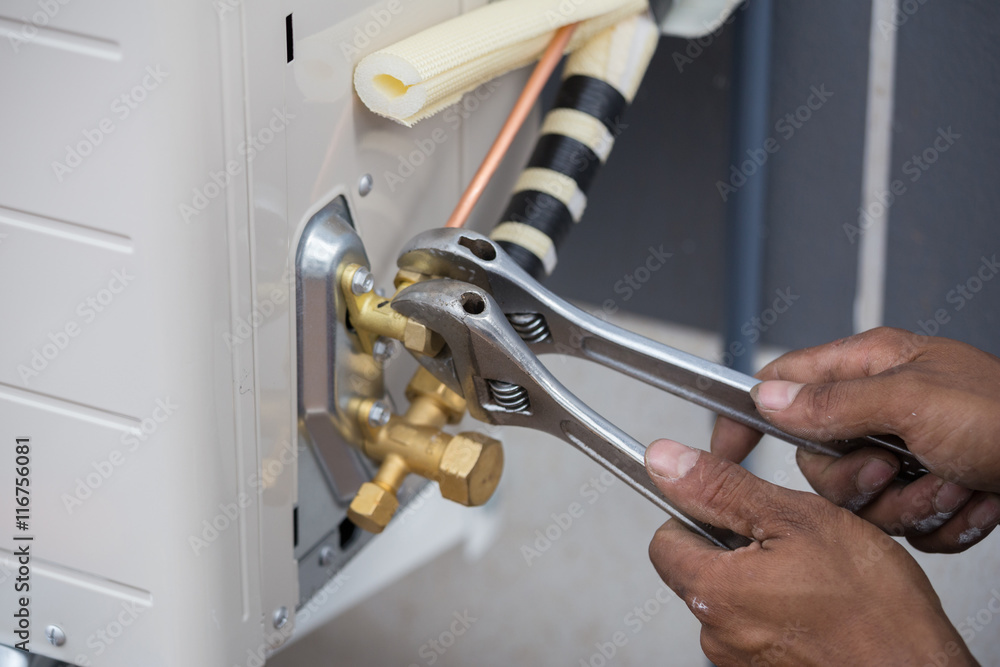 installation of air conditioner, worker connects copper pipe Stock ...