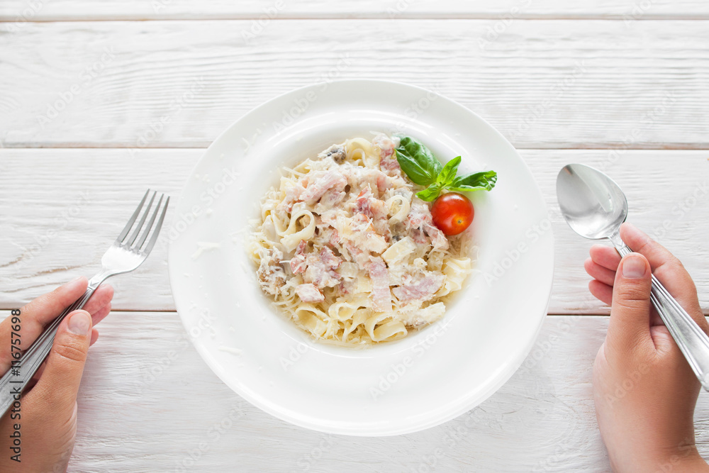 Spaghetti carbonara eating with fork and spoon, eater pov, flat lay ...