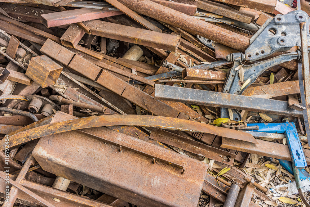 Garbage dump of waste metals. The rusty irons and steels are waiting ...