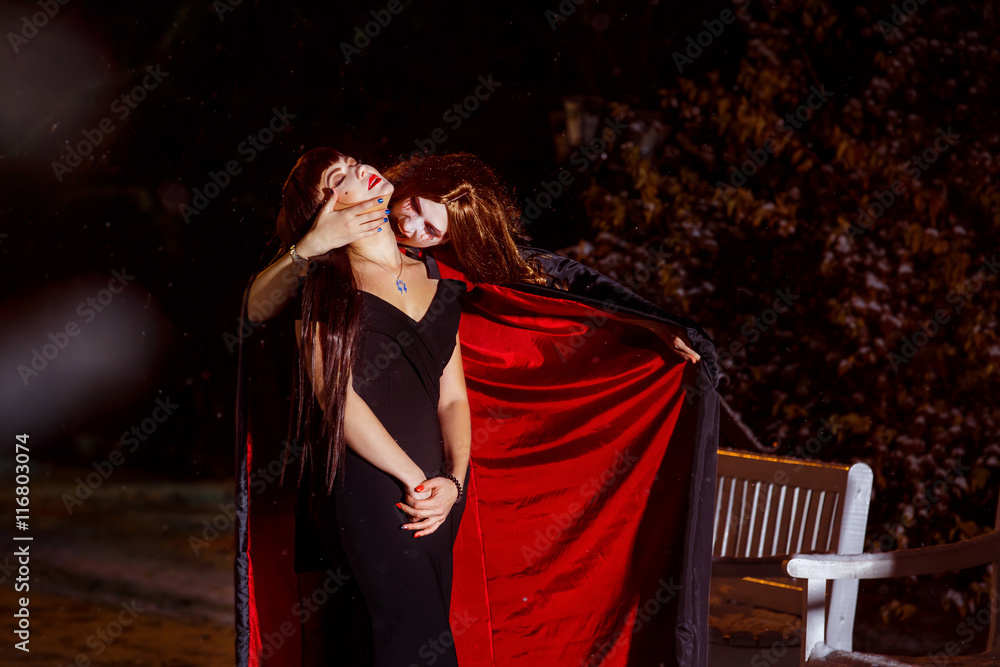 Portrait of a vampire girl drinking blood of victim outdoors Stock ...